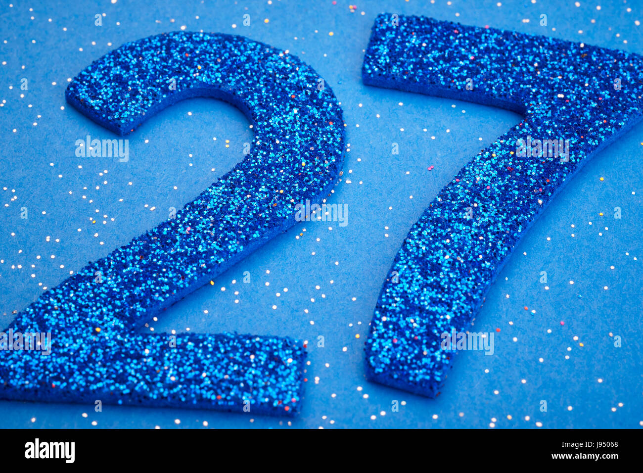 Number twentyseven blue color over a blue background. Anniversary ...