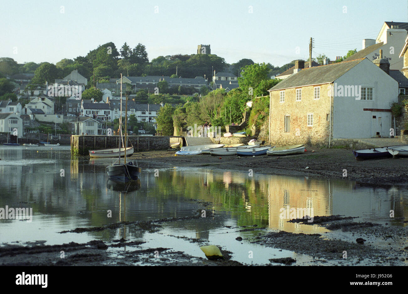 Noss Mayo with estuary at low tide, lit by evening sunset, Devon ...