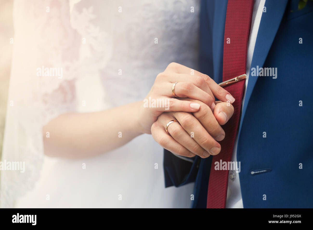 Young married couple holding hands, ceremony wedding day Stock Photo ...