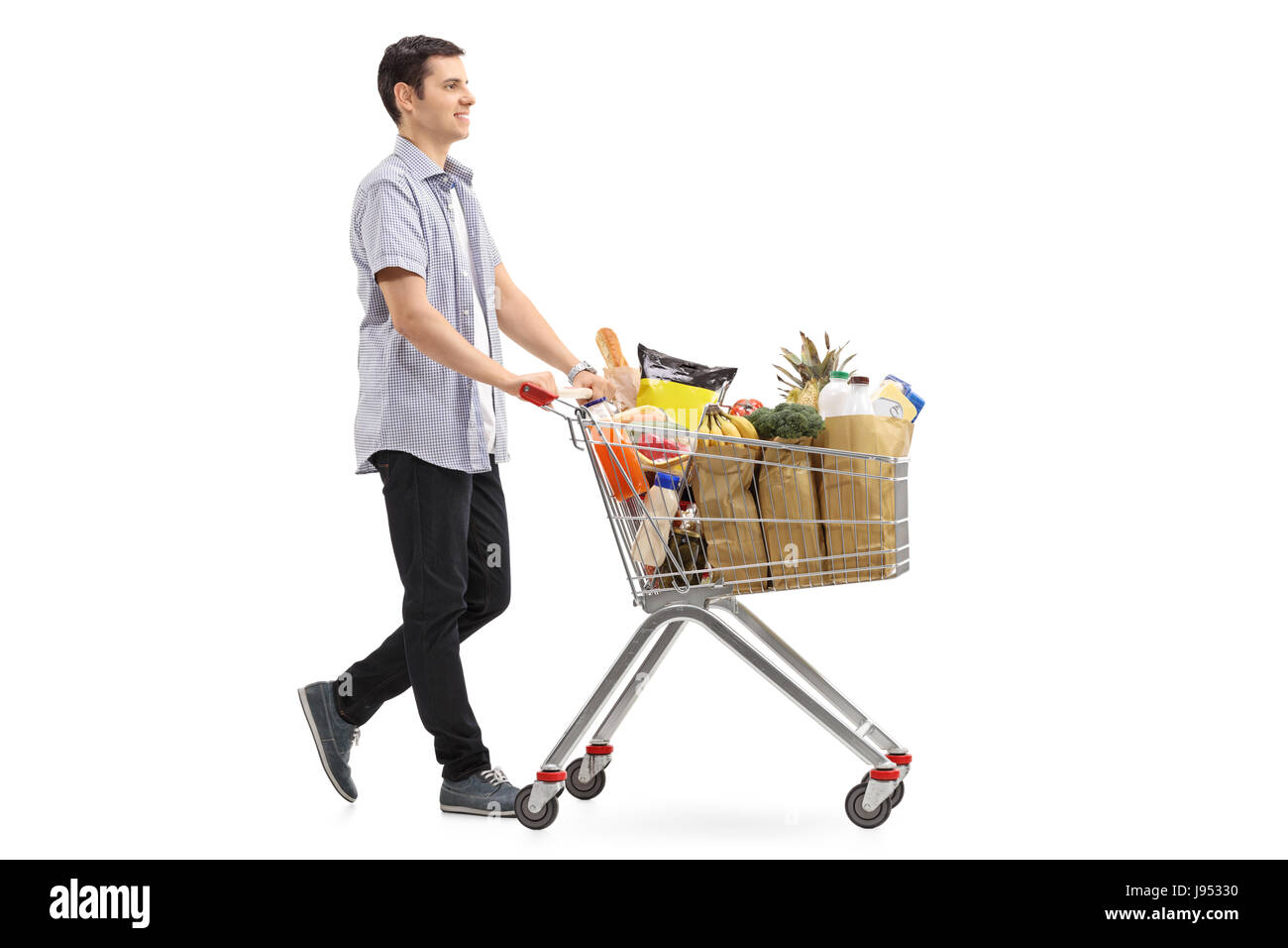 Full length profile shot of a young man pushing a shopping cart filled ...