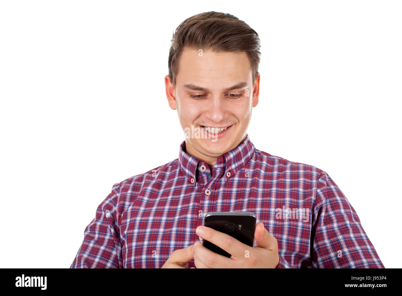 Picture of a happy young man sending a text message Stock Photo - Alamy