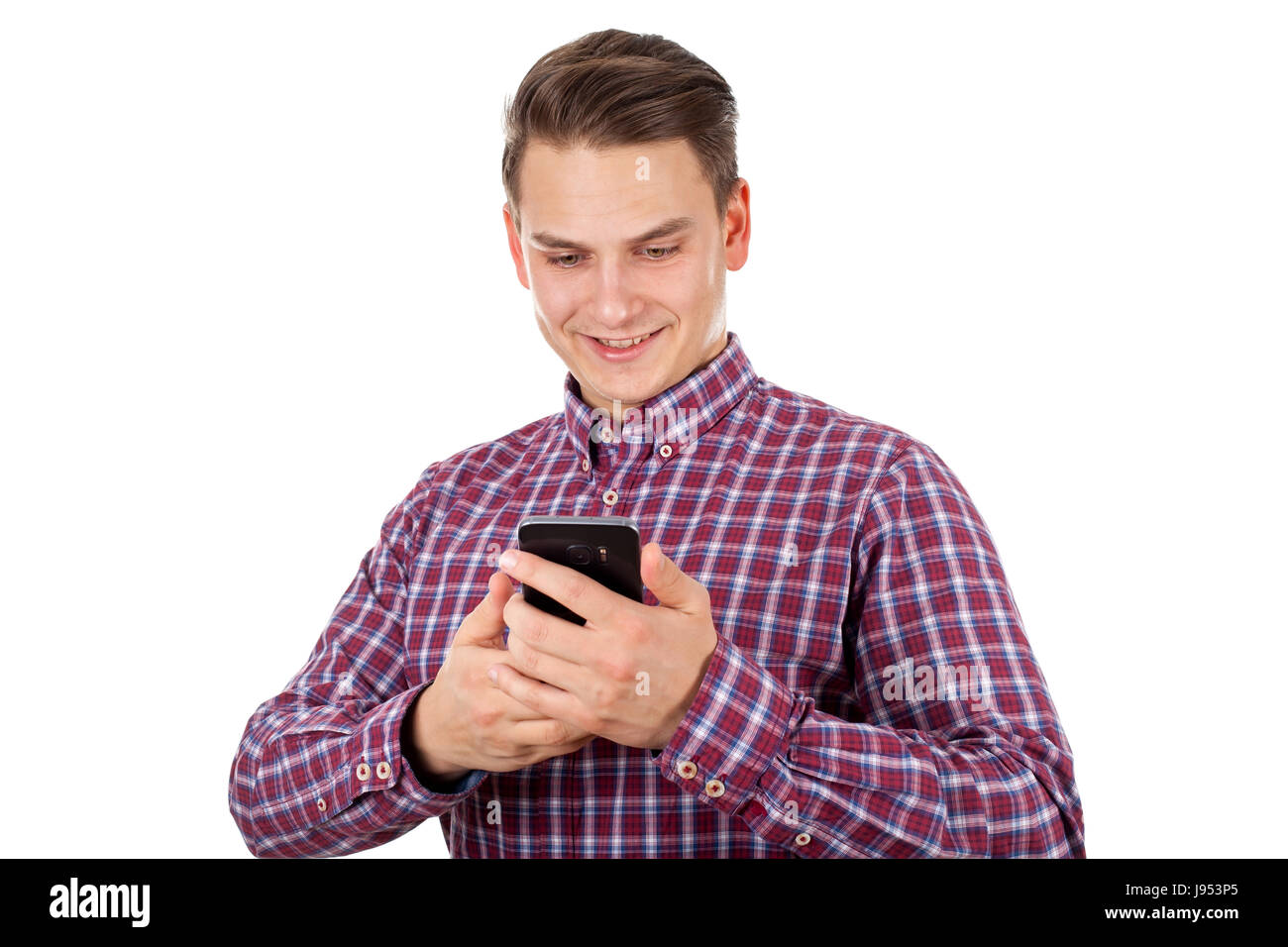 Picture of a happy young man sending a text message Stock Photo - Alamy