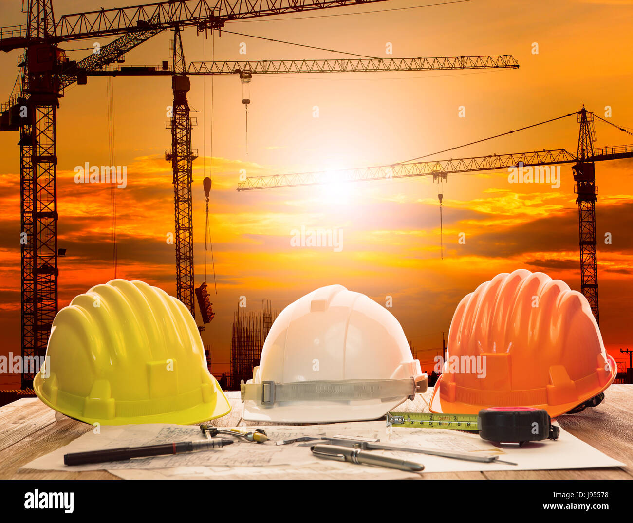 crane in construction site and working table of civil engineer with ...