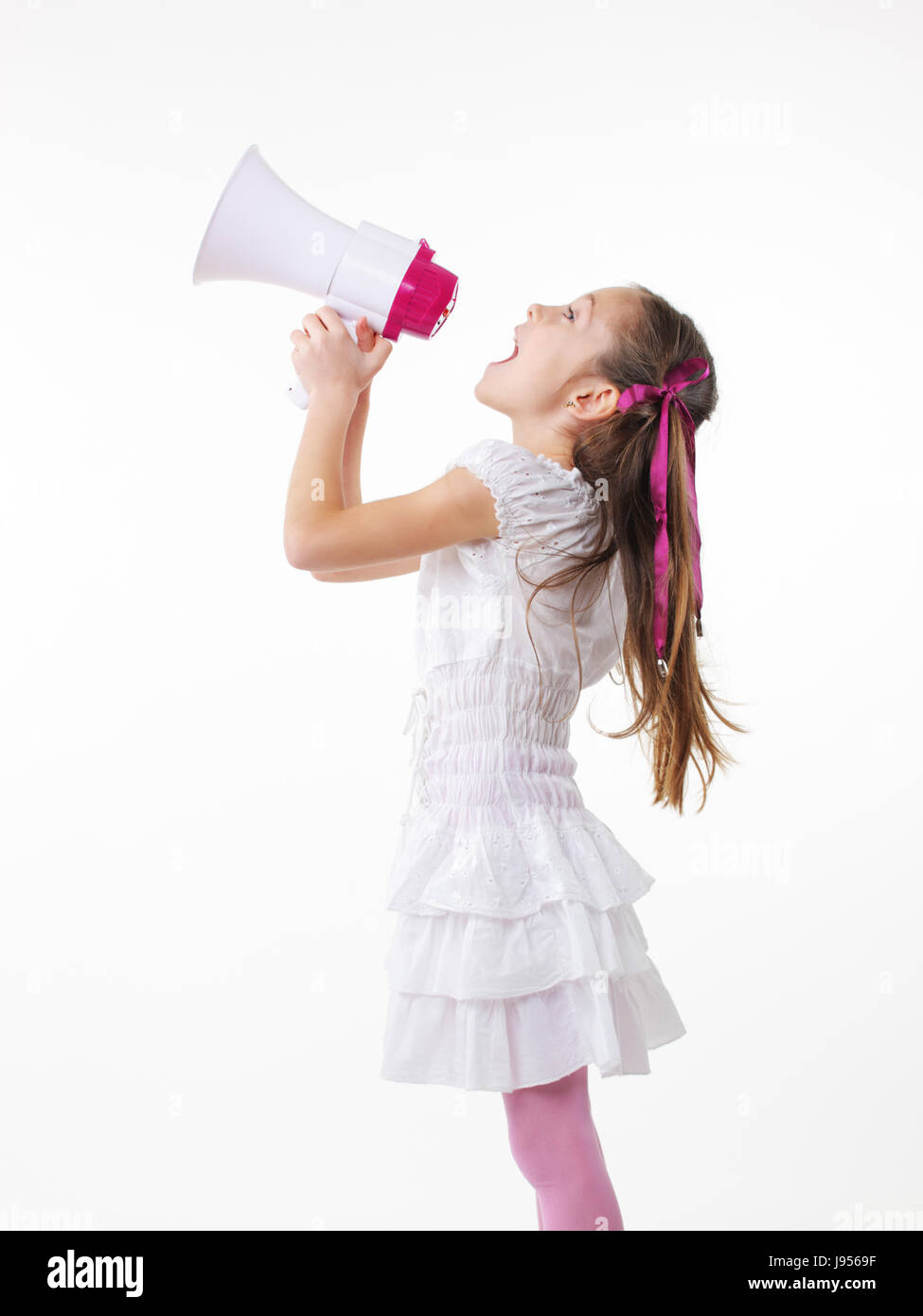 Young little girl shouting through megaphone Stock Photo - Alamy