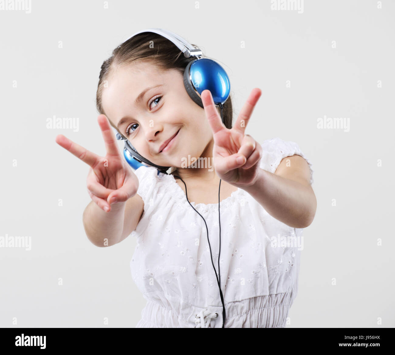 Beautiful girl shows a symbol of a victory Stock Photo - Alamy