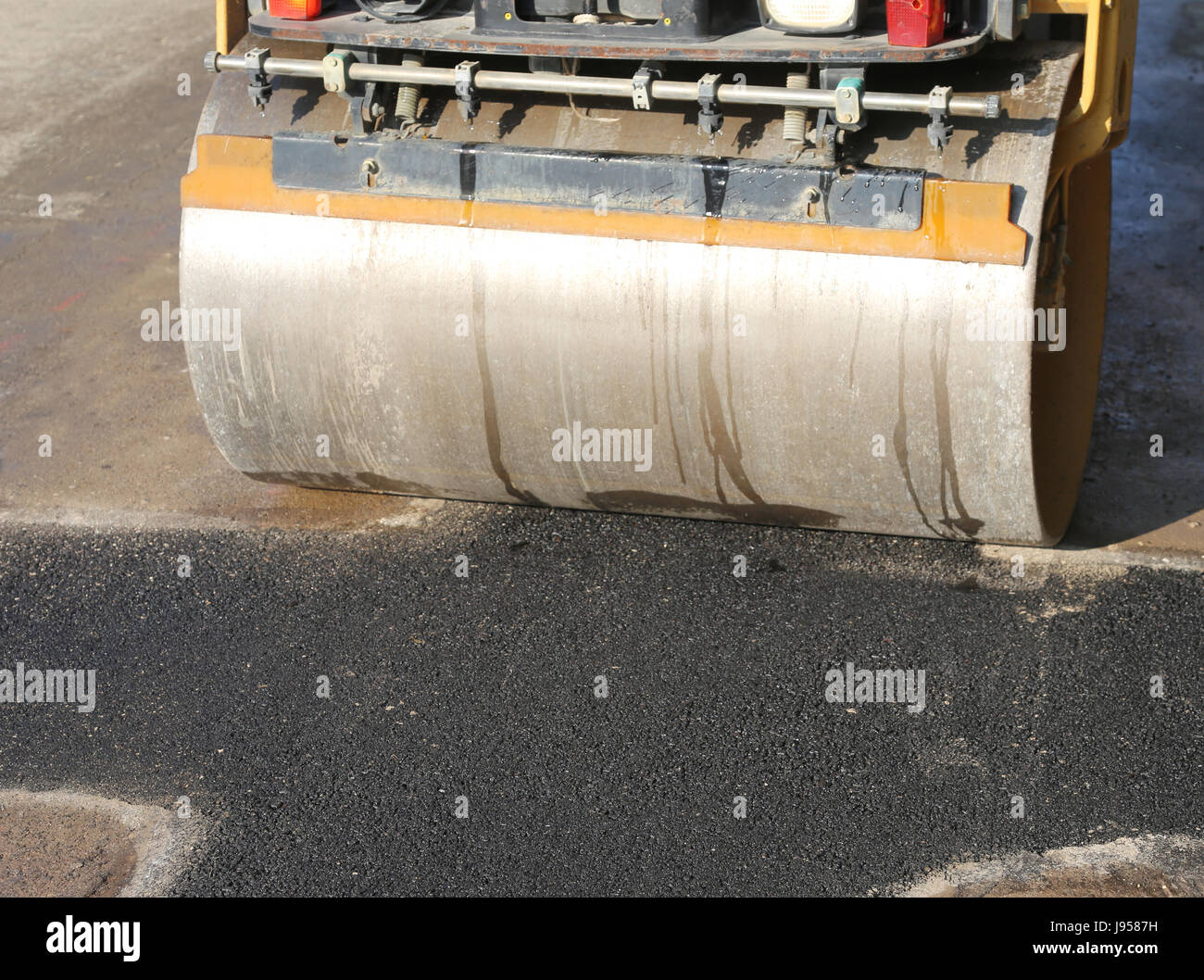 little steamroller during the asphalt laying on the road construction ...