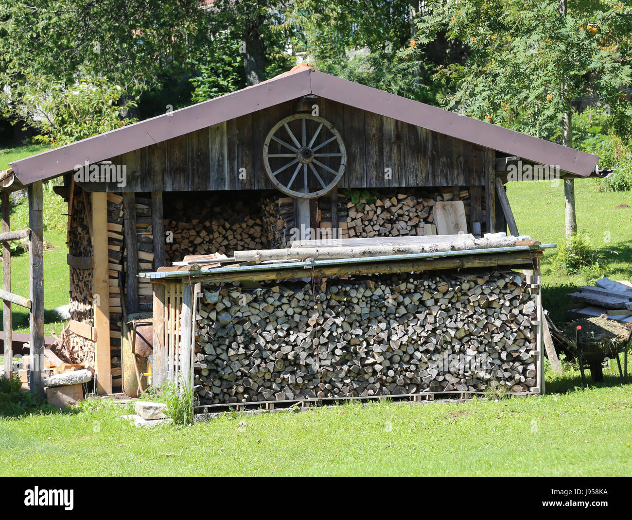 Woodhouse storage of a mountain house with green lawn in summer Stock ...
