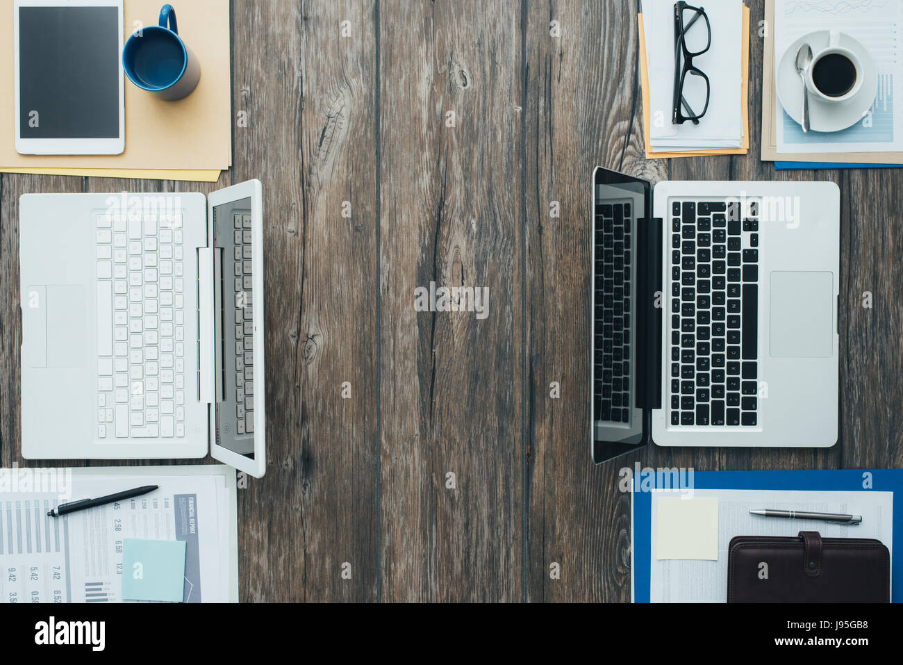 Office workspace with laptops, accessories and paperwork, business ...