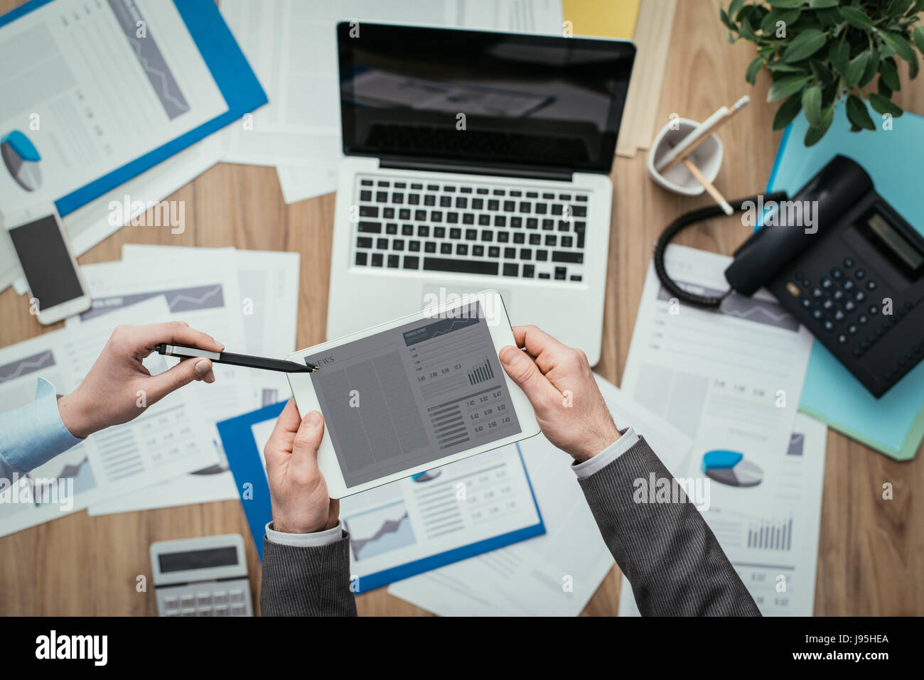 Business people meeting in the office and using a digital tablet, the ...