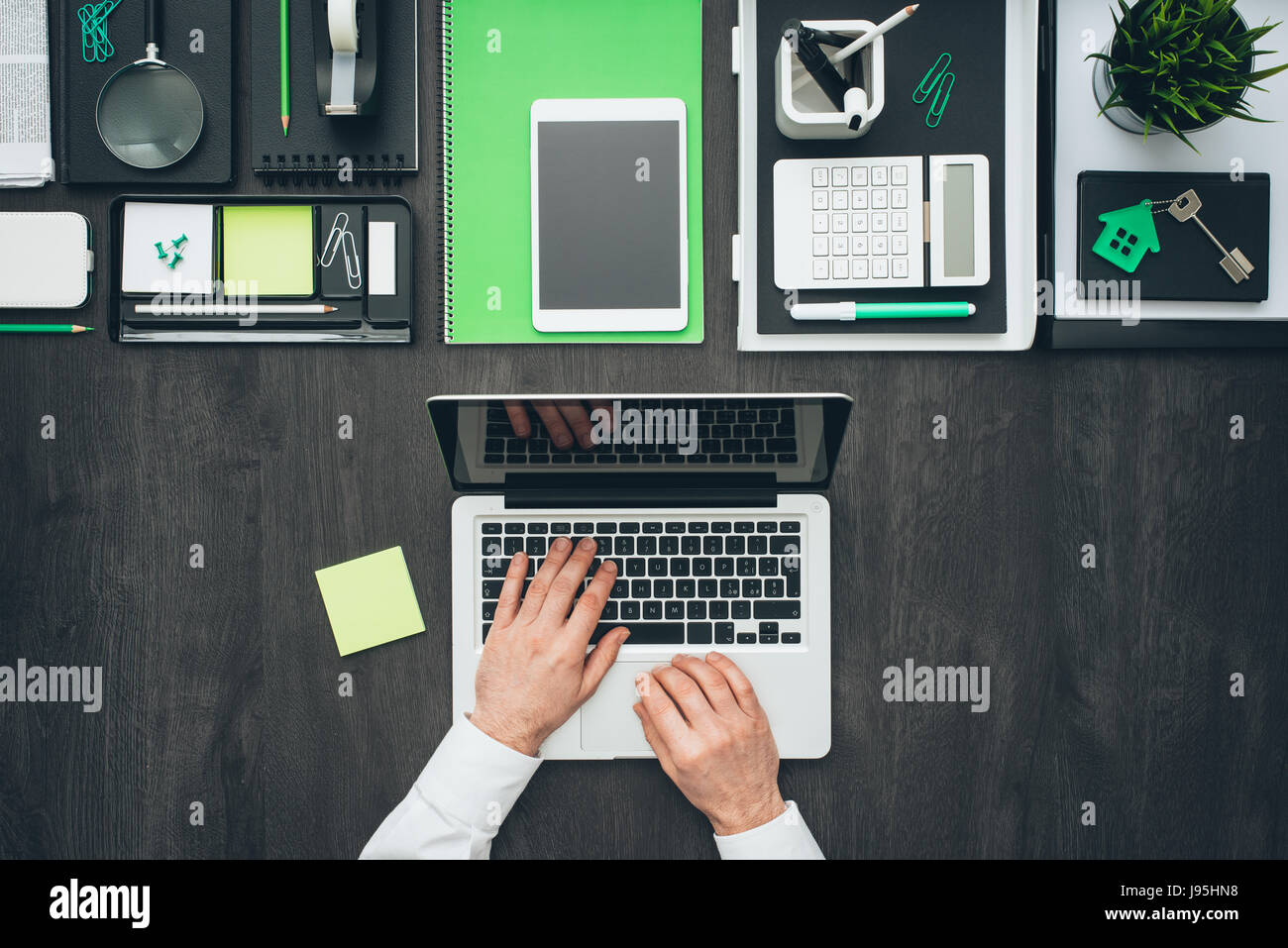 Corporate businessman working at office desk and networking with a ...
