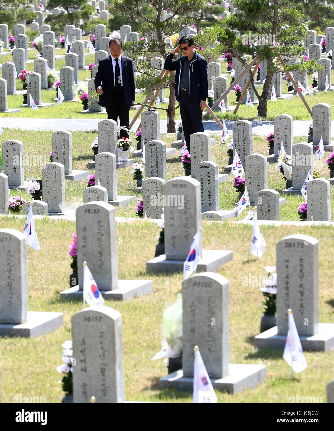 Paying respects to martyrs A family member pays respects with a salute ...
