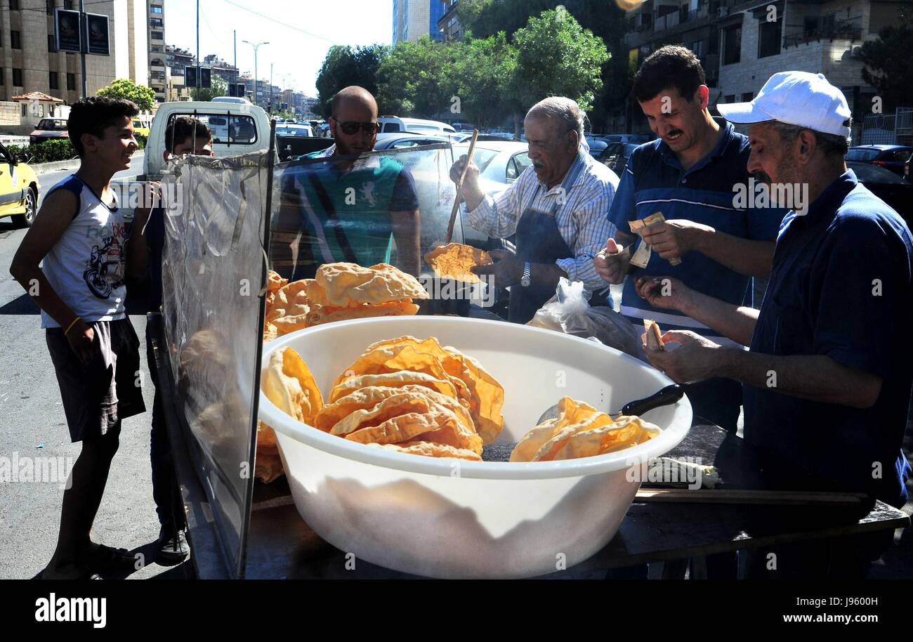 Damascus, Syria. 5th June, 2017. Syrians buy the Naem cake, a Syrian ...