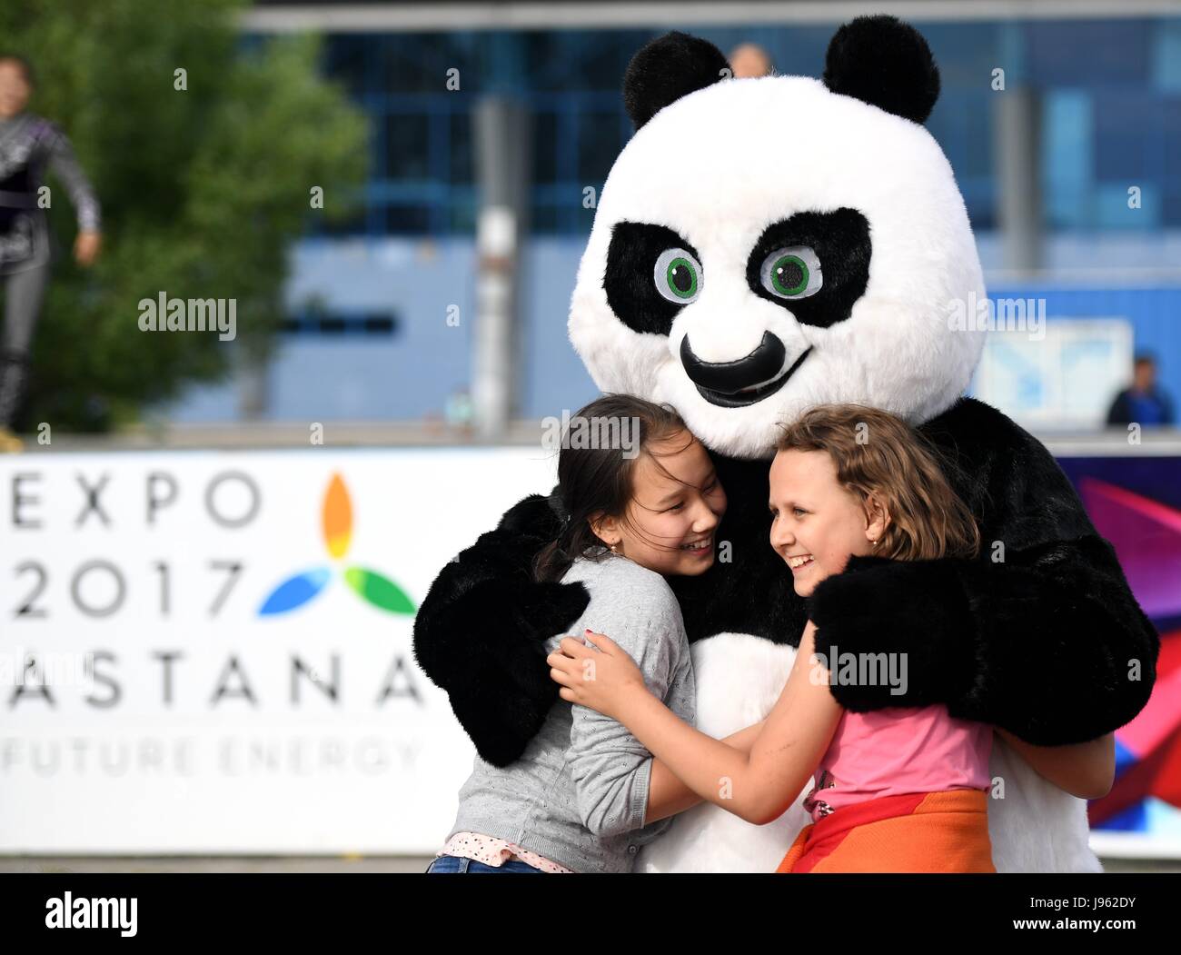 Astana, Kazakhstan. 5th June, 2017. Girls play with a dancer wearing ...