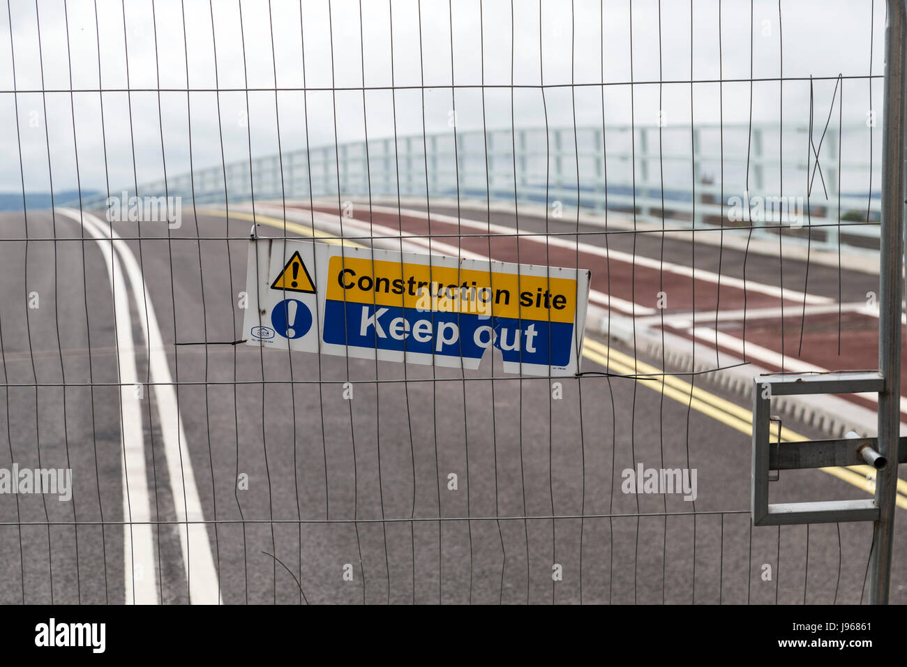 Barriers in place and Keep Out signs at the approach to an unfinished ...