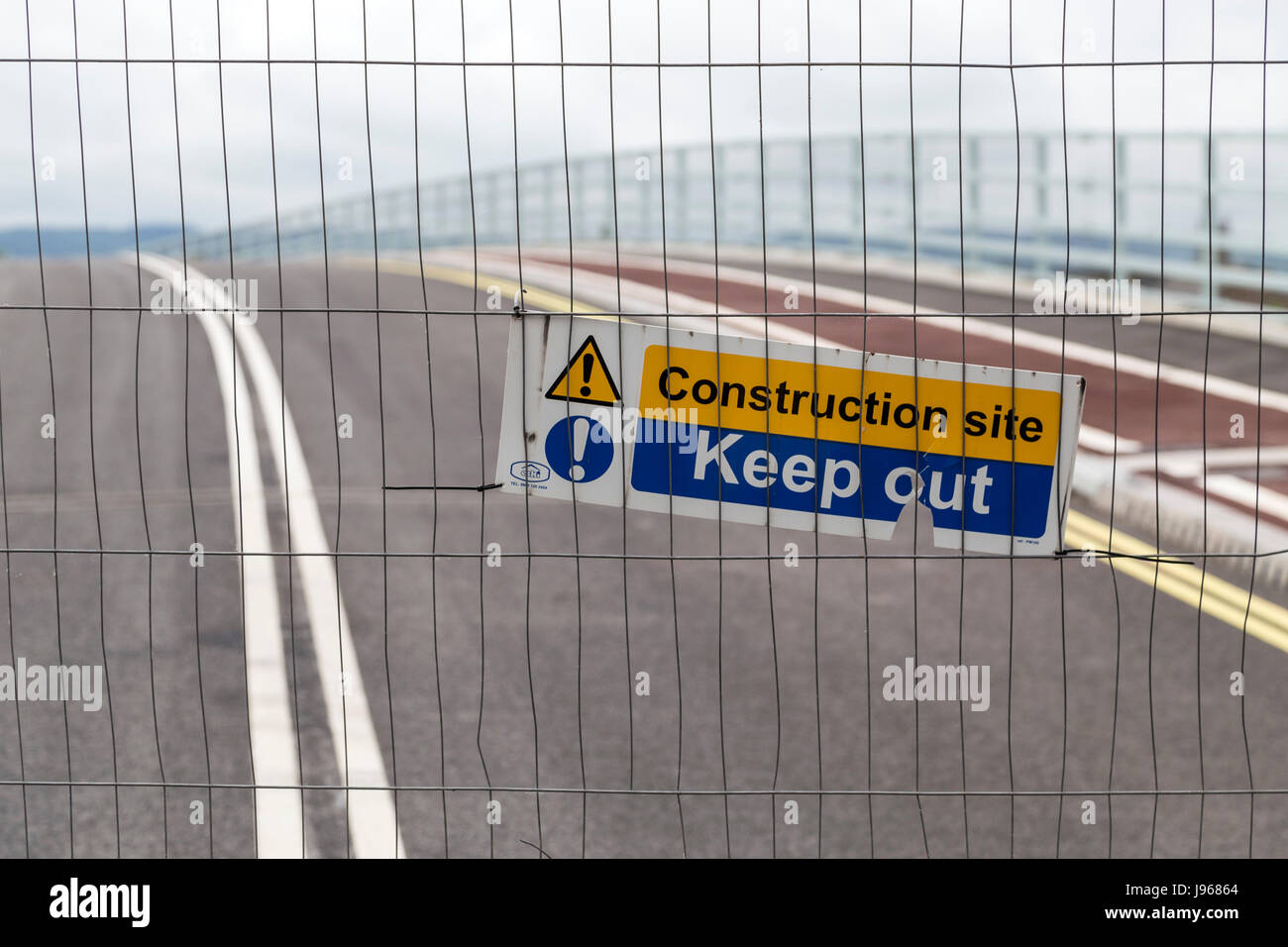 Barriers in place and Keep Out signs at the approach to an unfinished ...