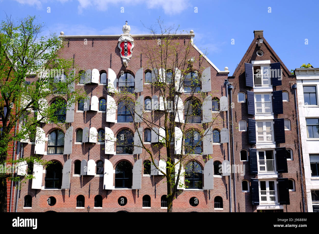front of large dutch canalside house in amsterdam with shutters Stock ...