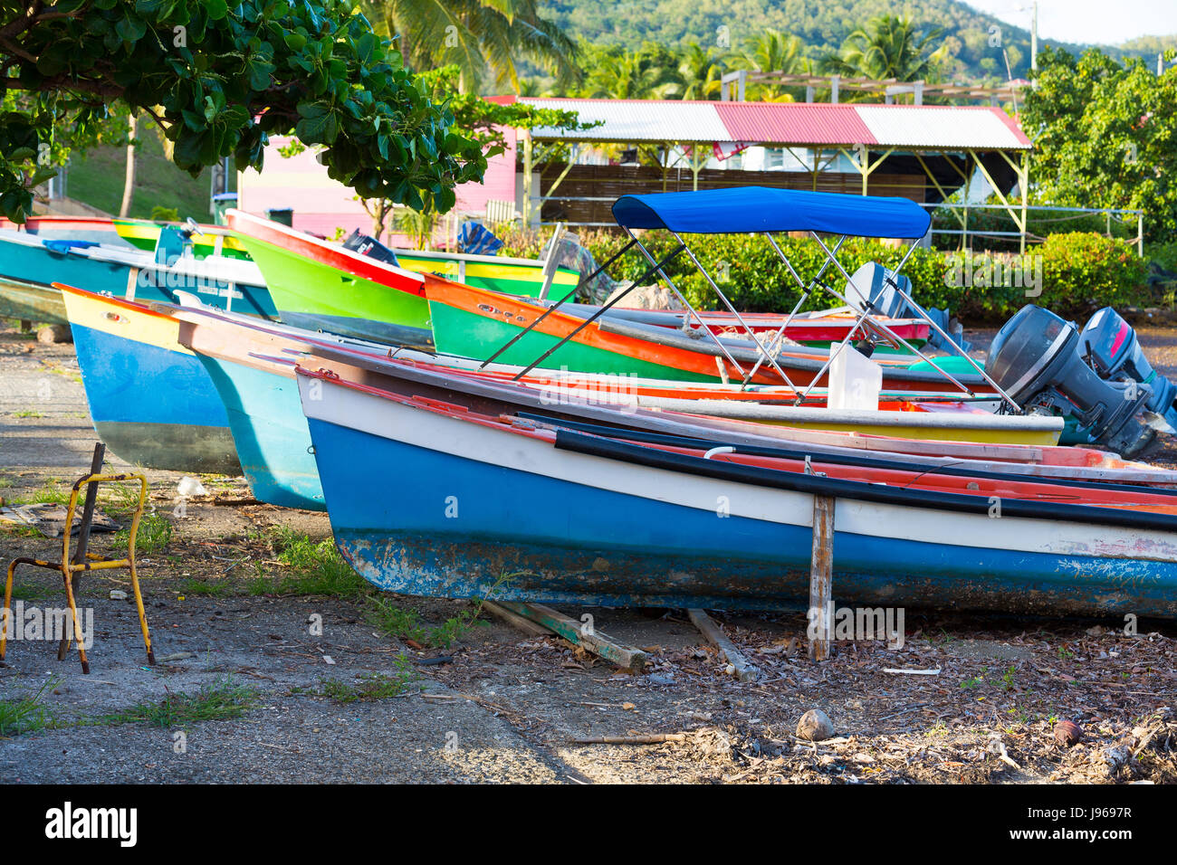 Colored small boats on Antilles sea, with blue sea Stock Photo - Alamy