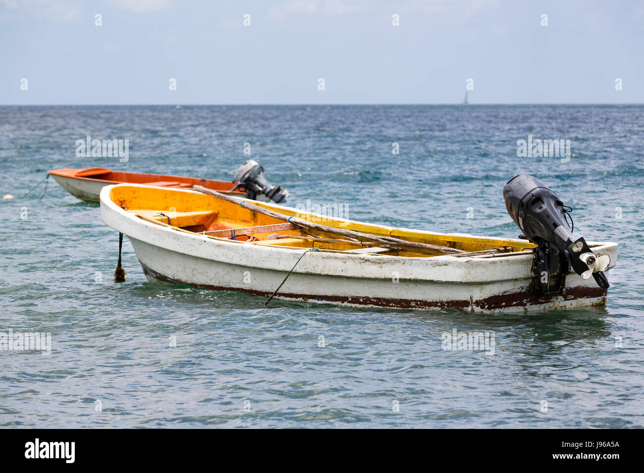 Colored small boats on Antilles sea, with blue sea Stock Photo - Alamy