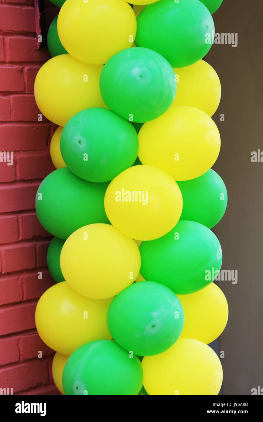 Multicolored yellow and green balloons adorn the entrance to the cafe ...