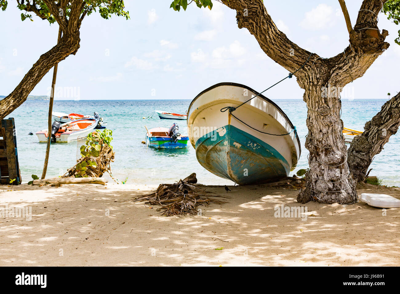 Colored small boats on Antilles sea, with blue sea Stock Photo - Alamy