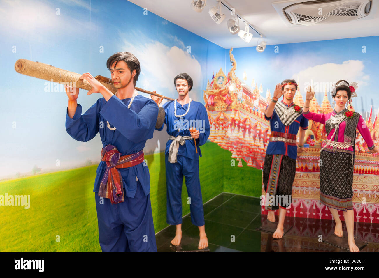 Figures of people carrying bamboo rocket during Boon Bang Fai (bamboo ...