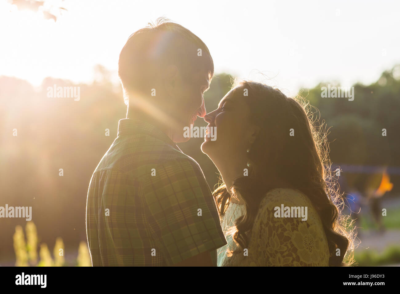 Closeup photo of romantic couple outdoors, side view Stock Photo - Alamy