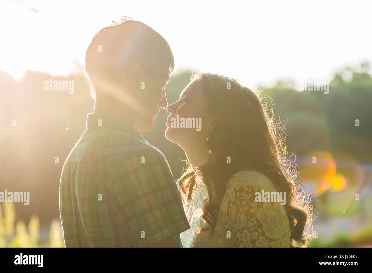 Closeup photo of romantic couple outdoors, side view Stock Photo - Alamy