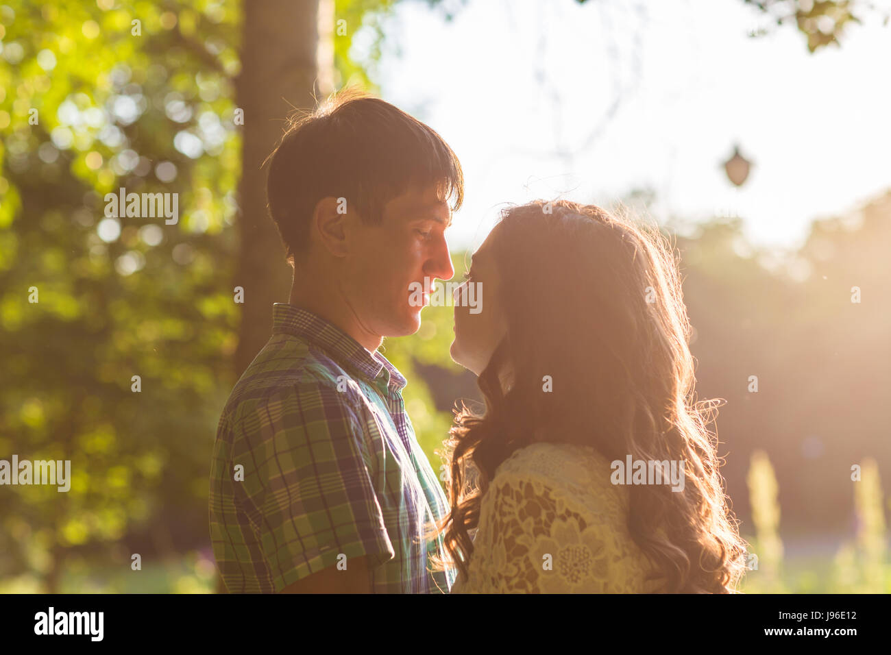 Closeup photo of romantic couple outdoors, side view Stock Photo - Alamy