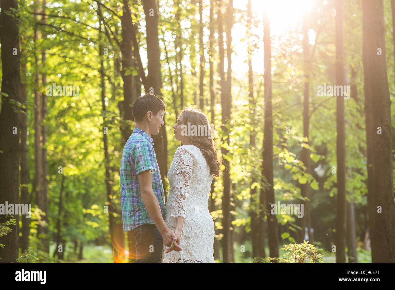 Portrait of a young romantic couple embracing each other on nature ...