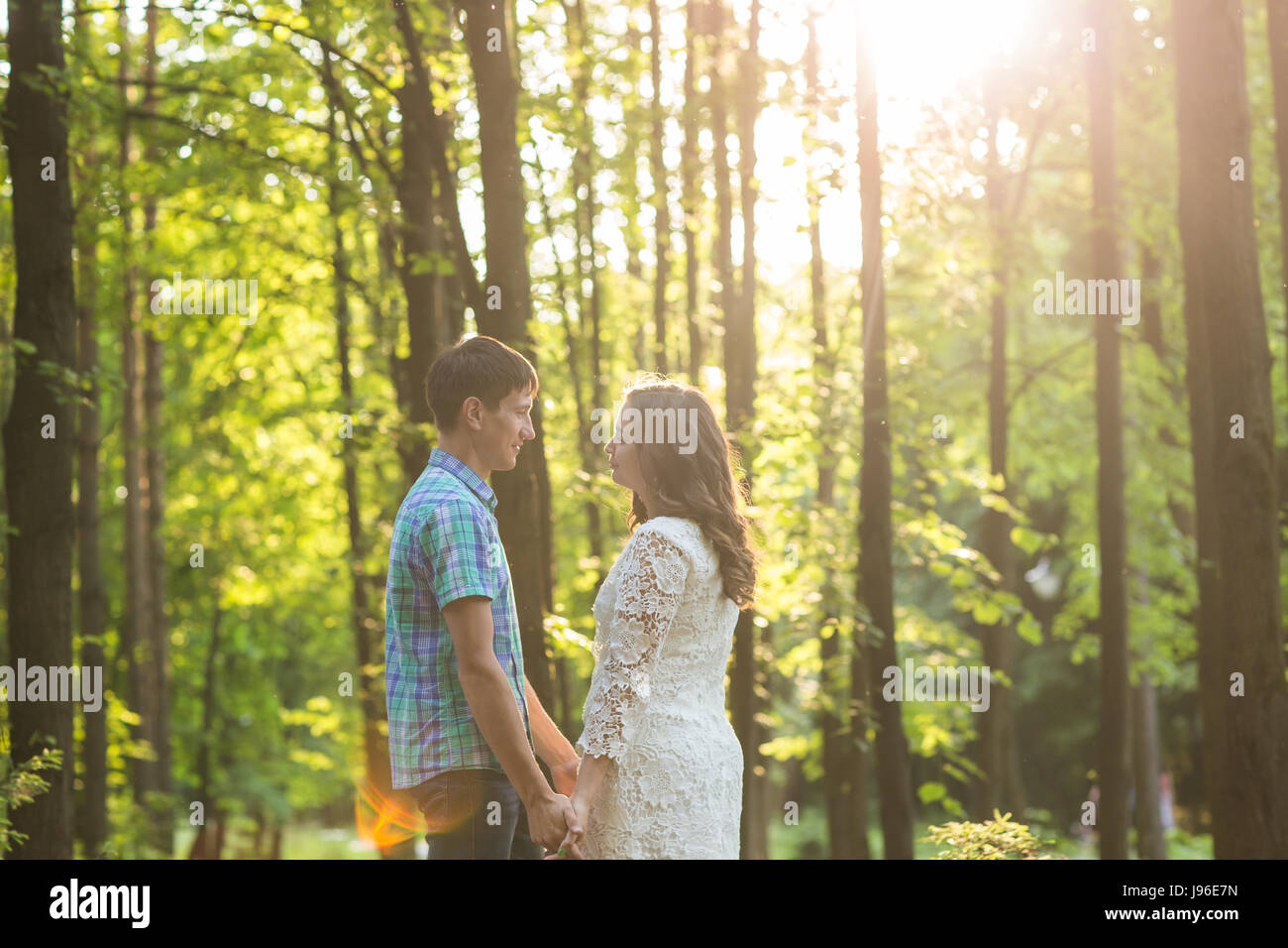 Portrait of a young romantic couple embracing each other on nature ...
