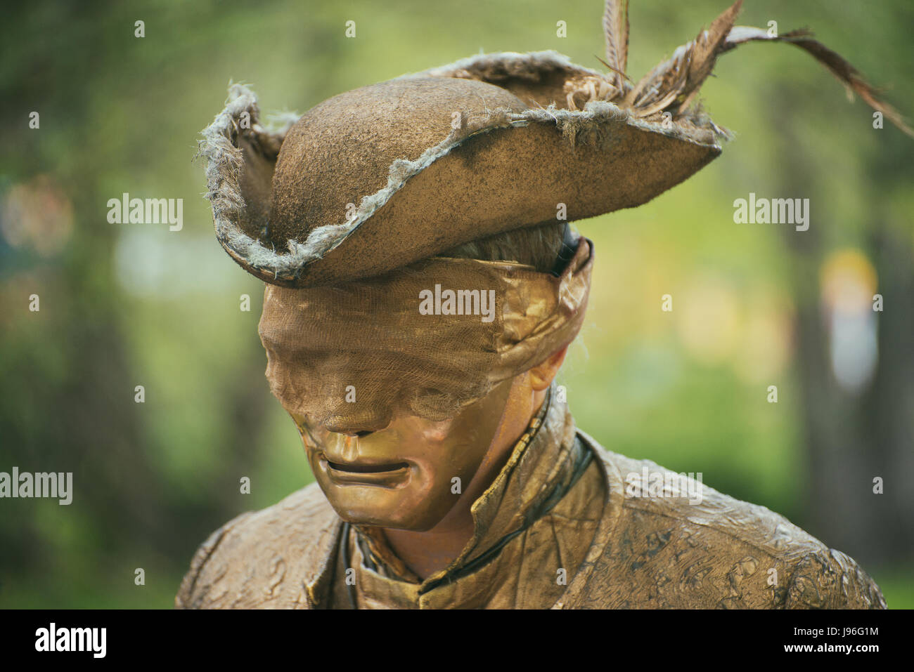 Unrecognizable golden man in mask on street carnival Stock Photo - Alamy