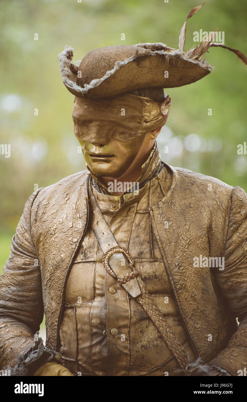 Unrecognizable golden man in mask on street carnival Stock Photo - Alamy