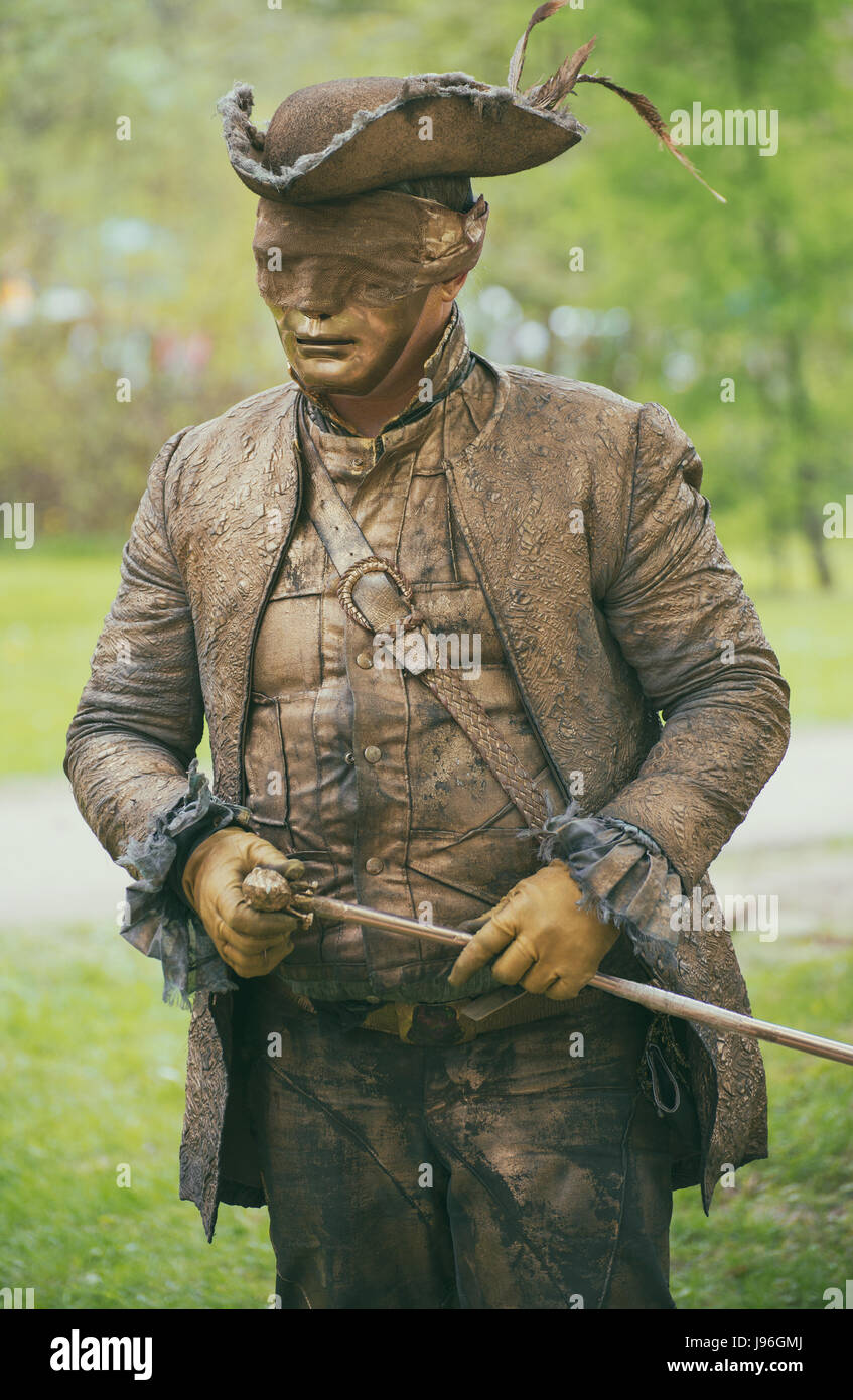 Unrecognizable golden man in mask on street carnival Stock Photo - Alamy