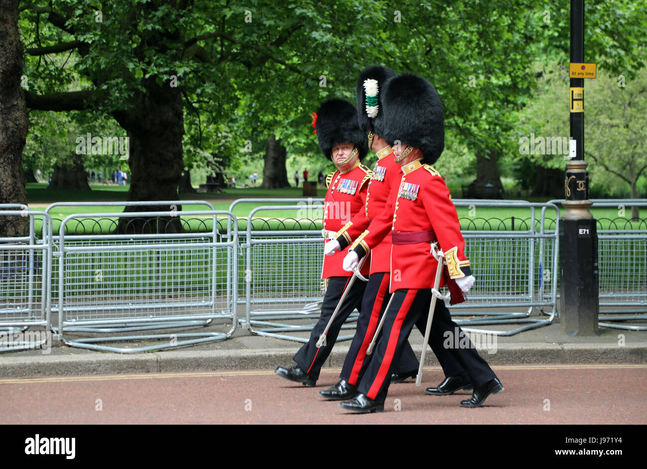 Three members of the Household Division walk down Horse Guards Parade ...