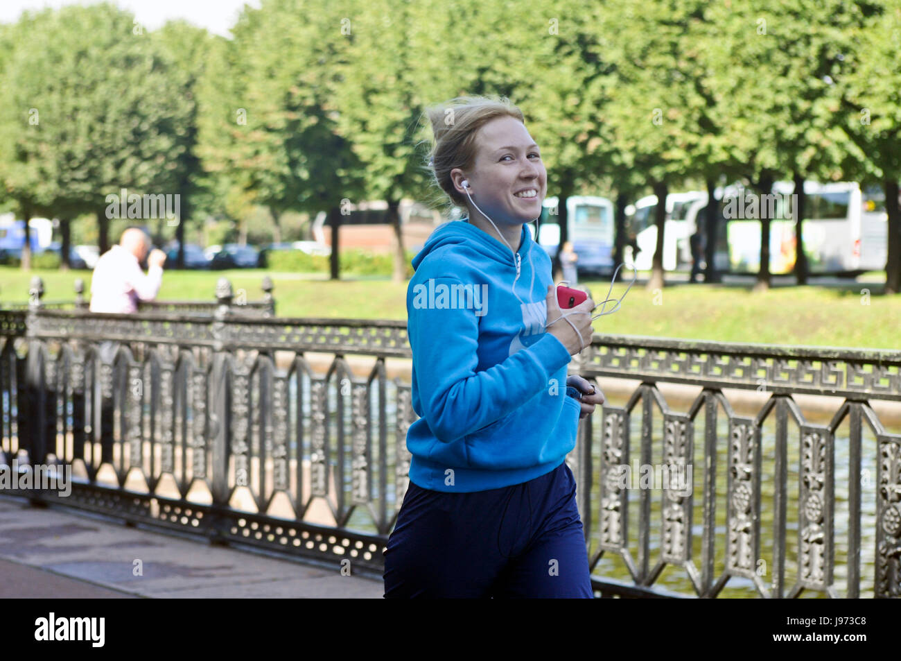 Blonde girl running at the park Stock Photo - Alamy