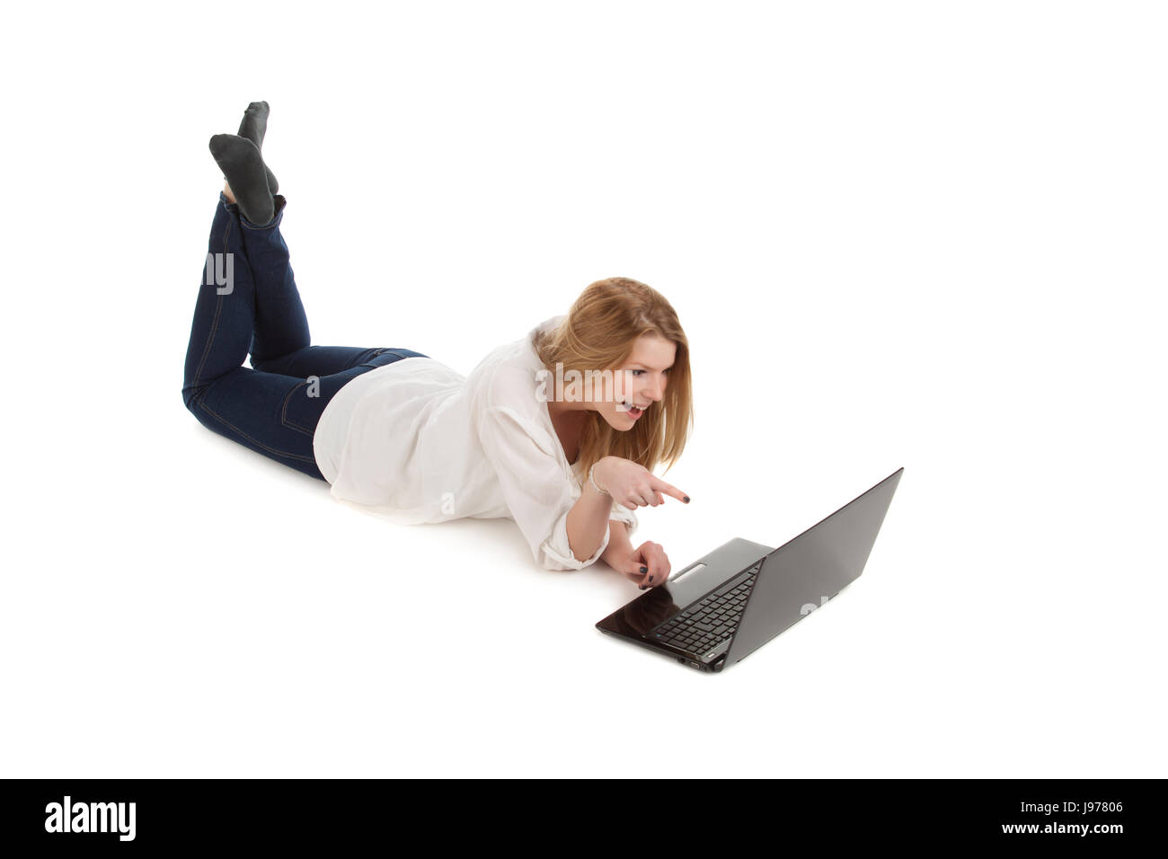 young blonde woman lying down with computer Stock Photo - Alamy