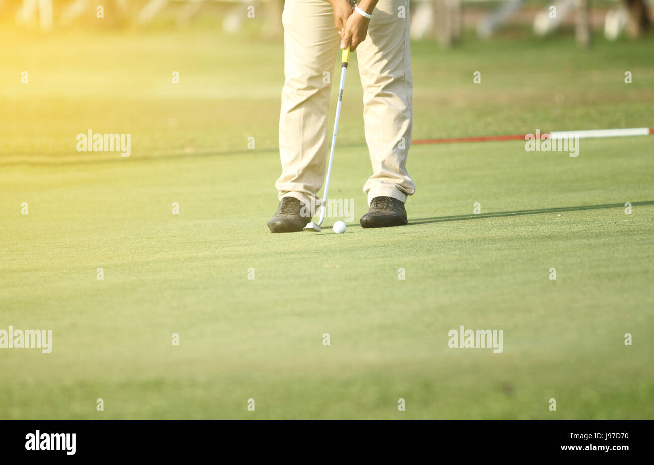 Asian golfers hit sweeping and keep golf course in the summer for relax ...