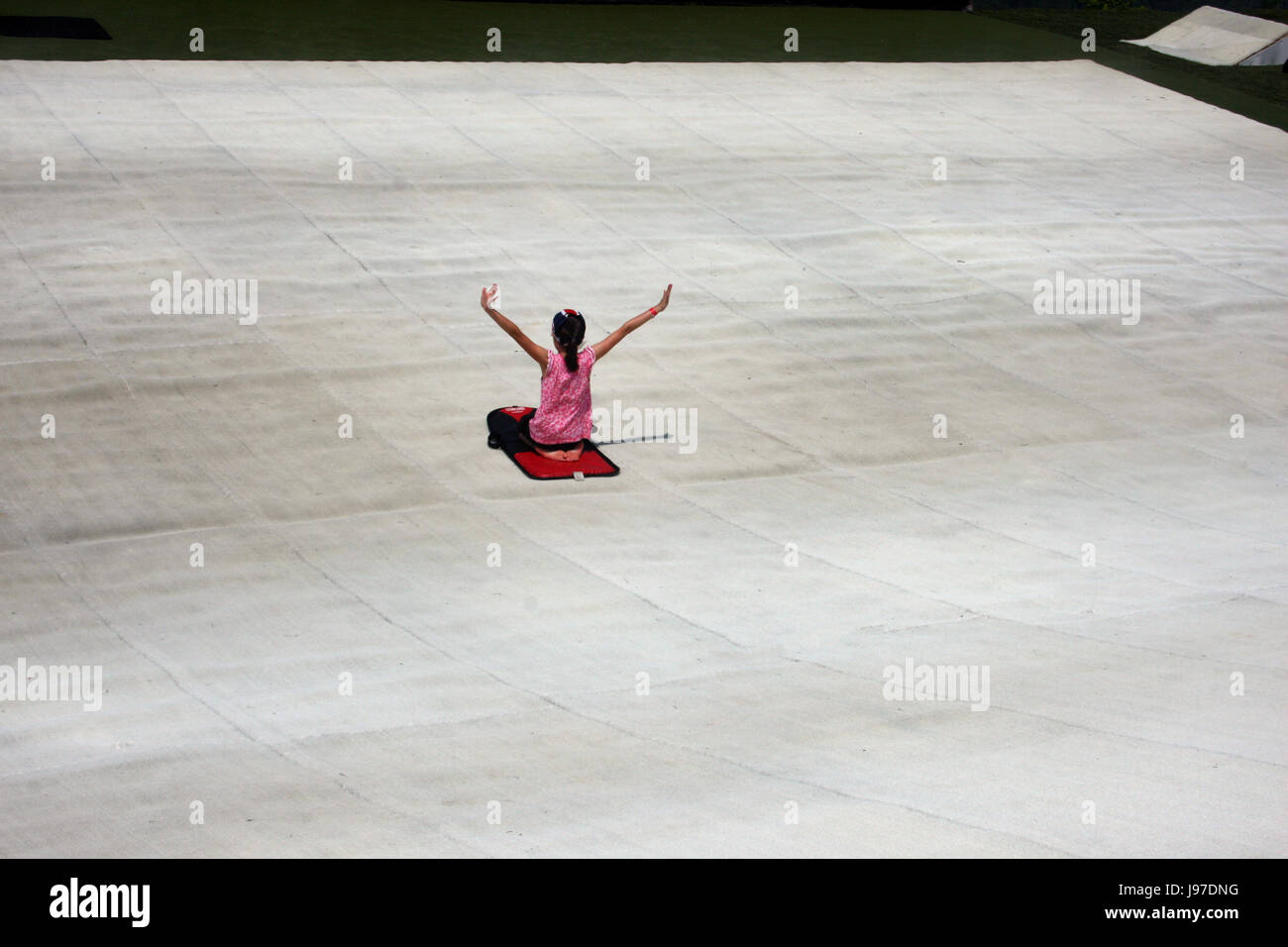 Little girl sliding down slope on artificial snow Stock Photo - Alamy