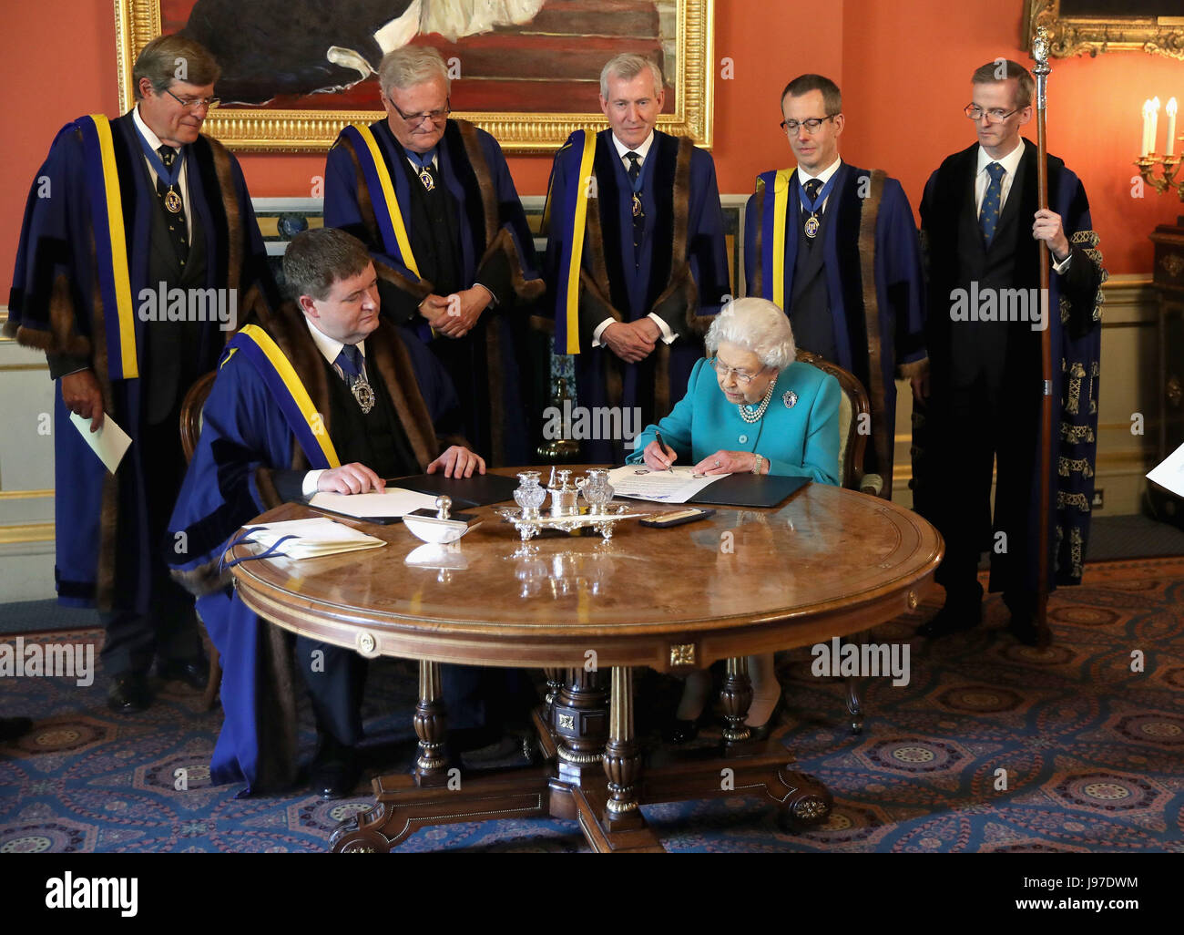 Queen Elizabeth II signs the Instrument, which is a document, written ...