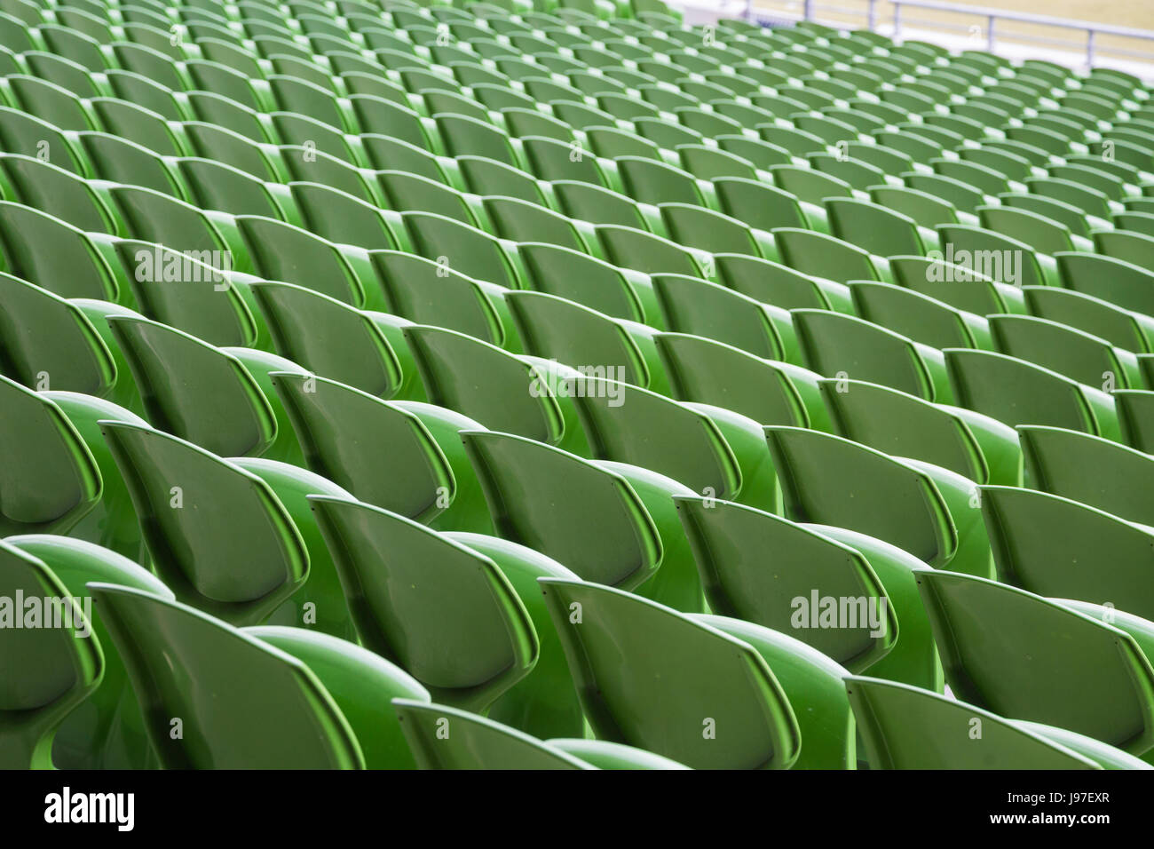 A row of empty green seats in a football stadium Stock Photo - Alamy
