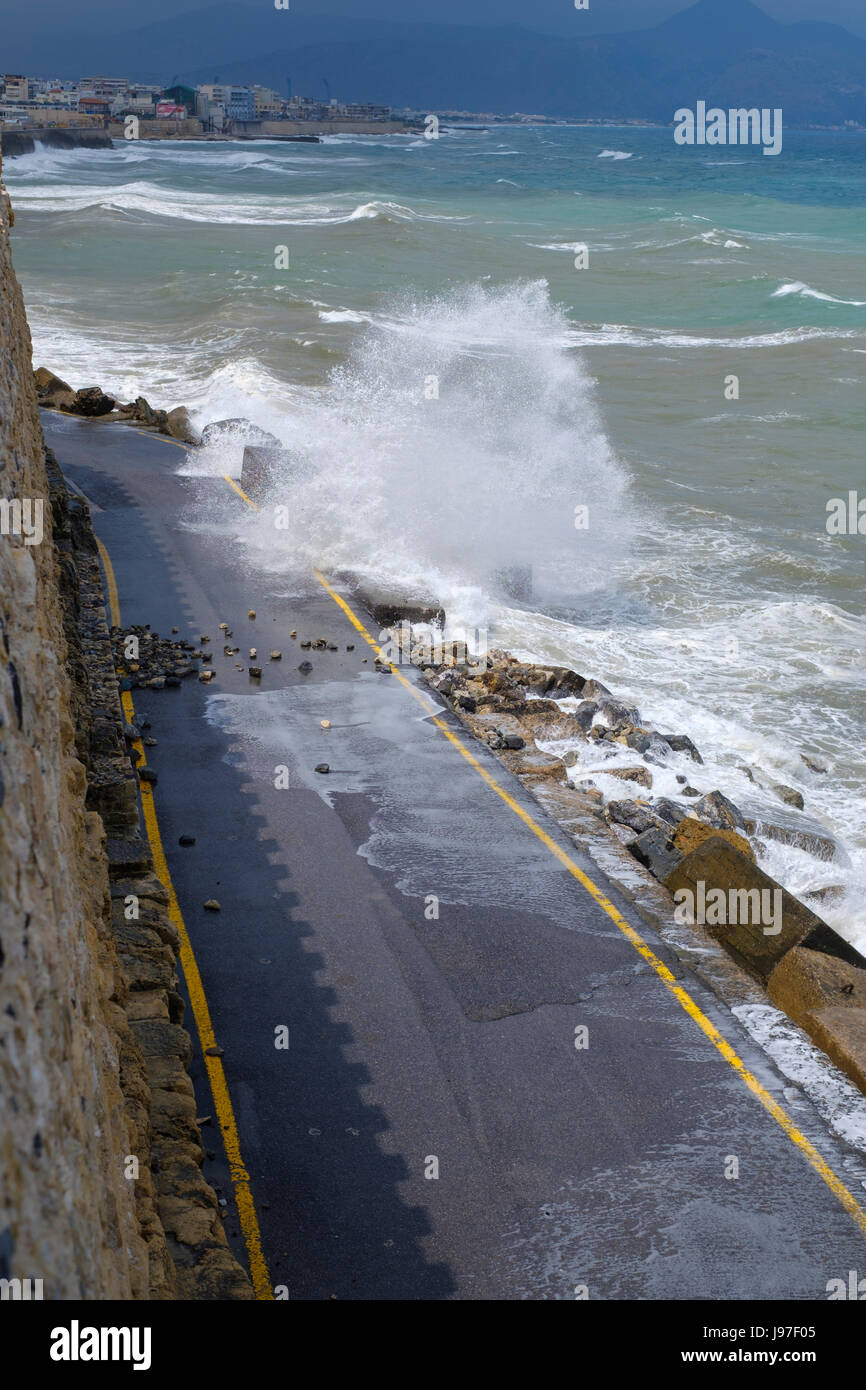 High waves caused by a heavy storm hit the quayside and destroy a paved ...