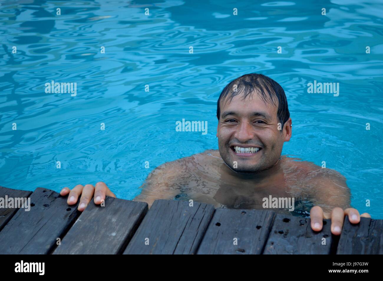 Happy young man enjoying the pool Stock Photo - Alamy