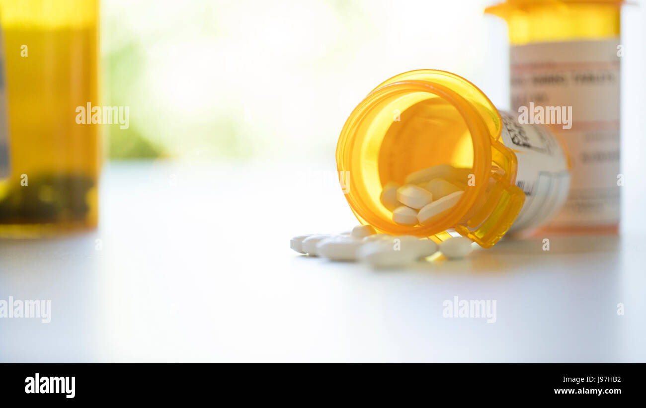Pill bottles on table Stock Photo - Alamy