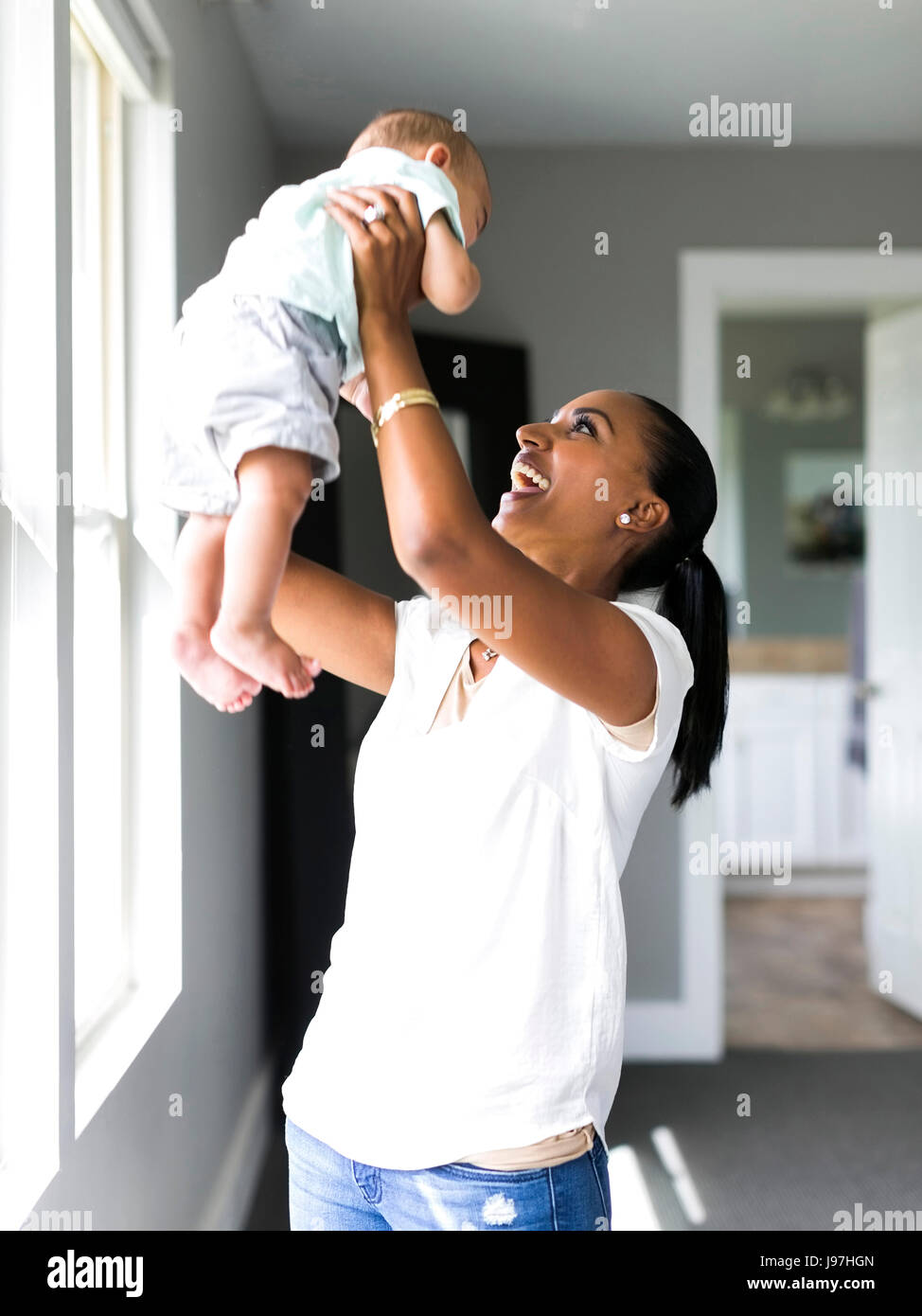 Mother holding aloft baby boy (2-5 months Stock Photo - Alamy