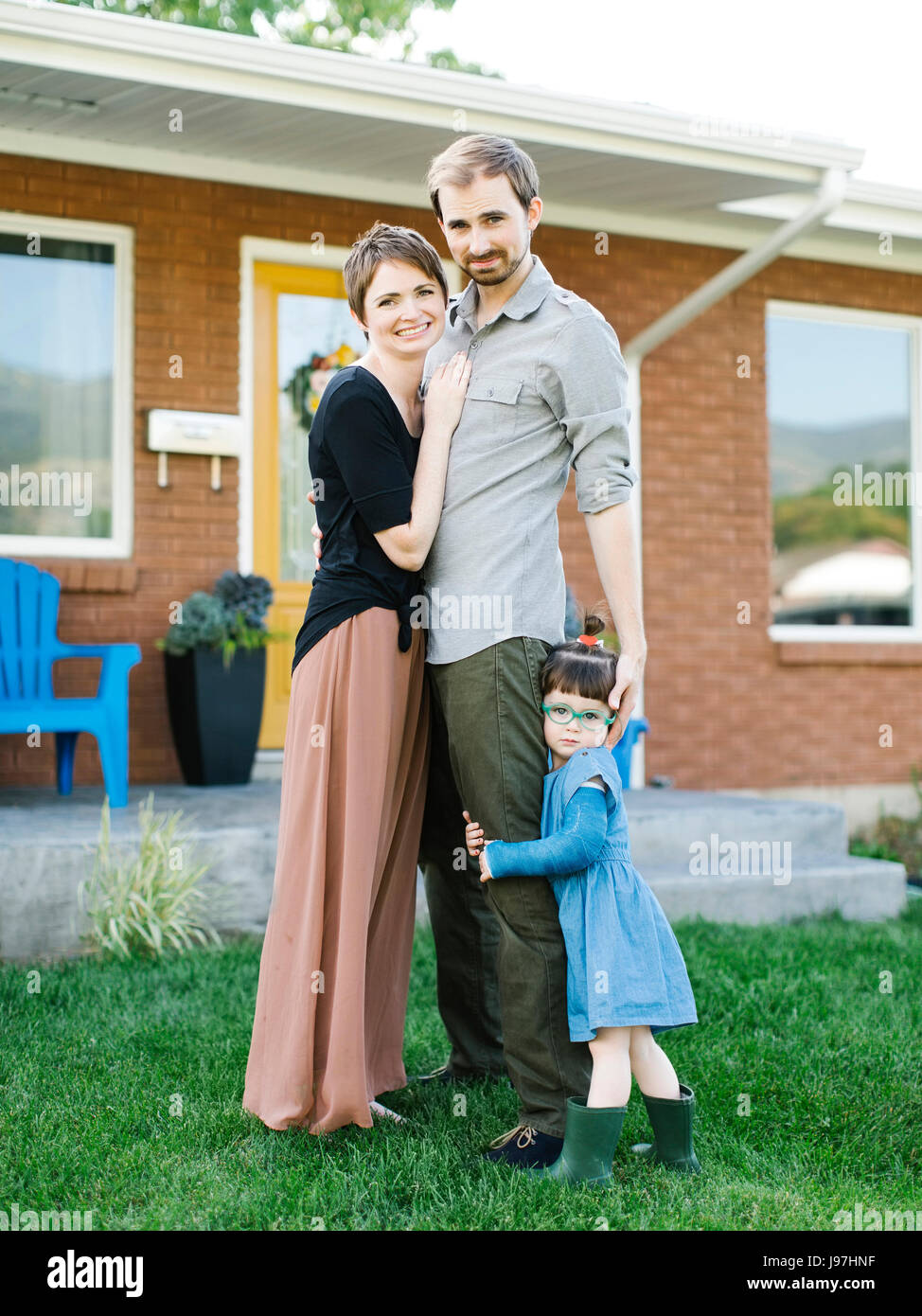 Family standing in front of house hi-res stock photography and images ...