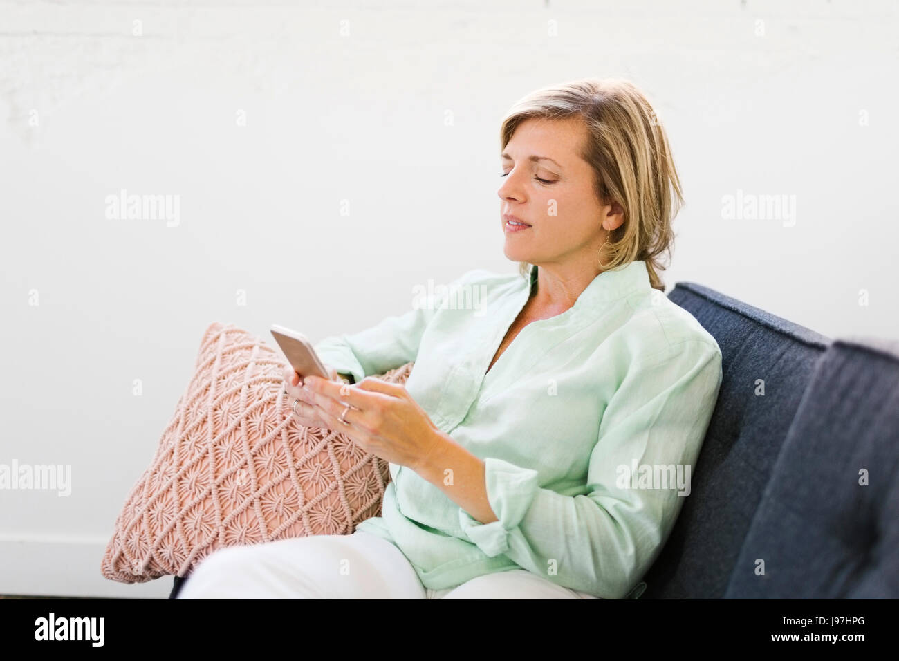 Mature woman using phone Stock Photo - Alamy