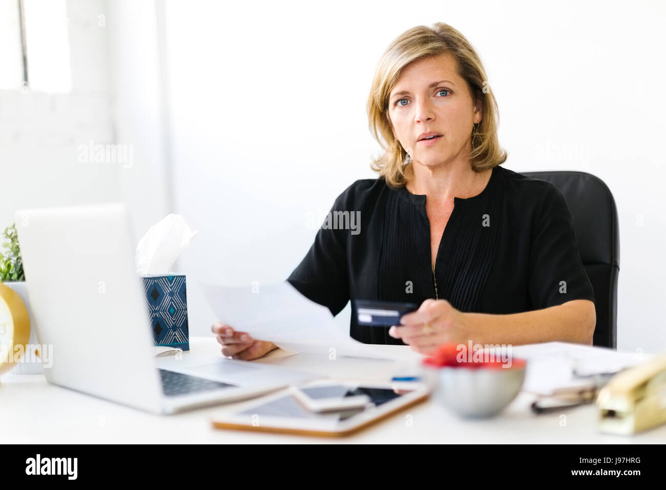 Portrait of Mature woman paying bills Stock Photo - Alamy
