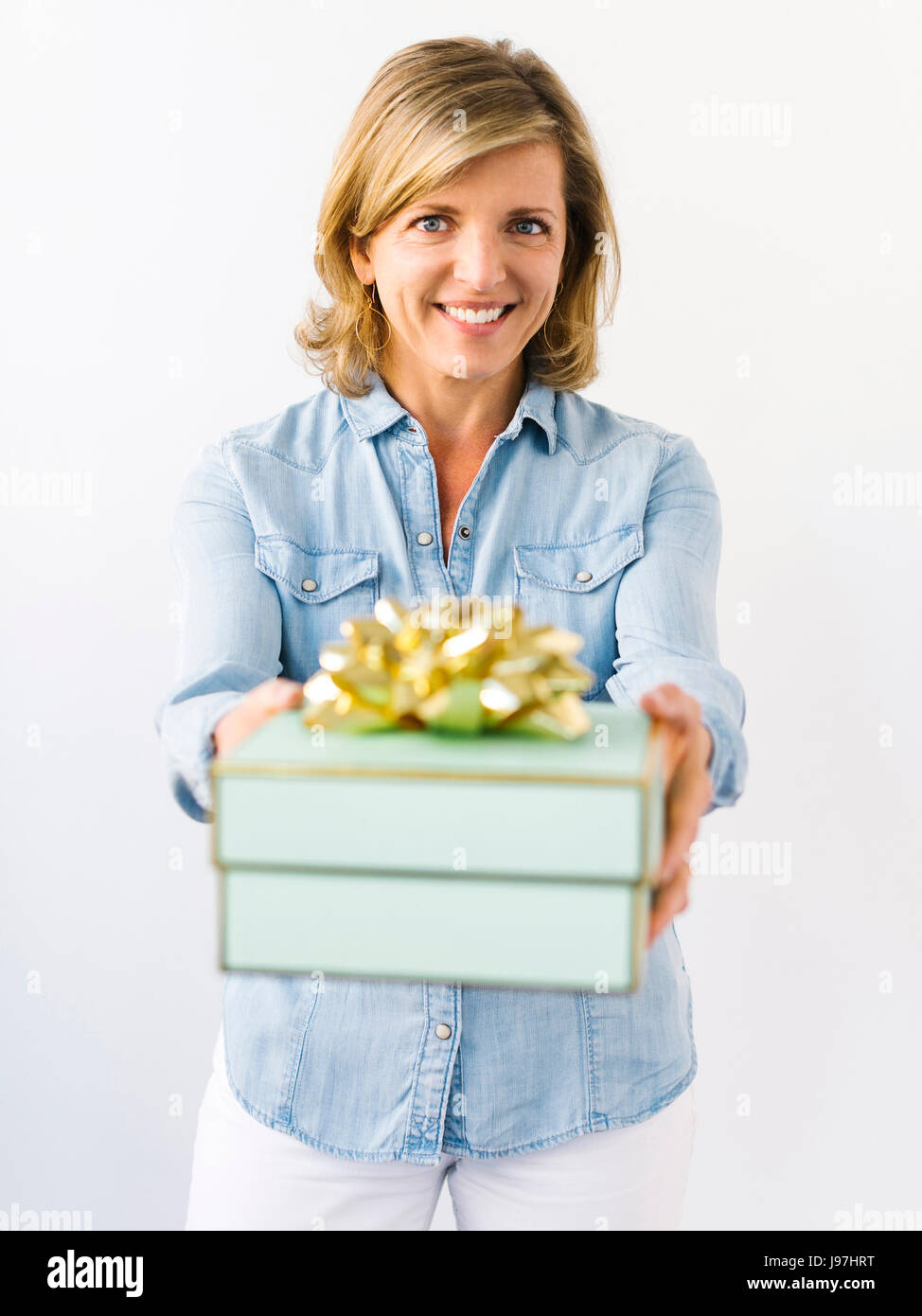 Portrait of Mature woman giving gift Stock Photo - Alamy
