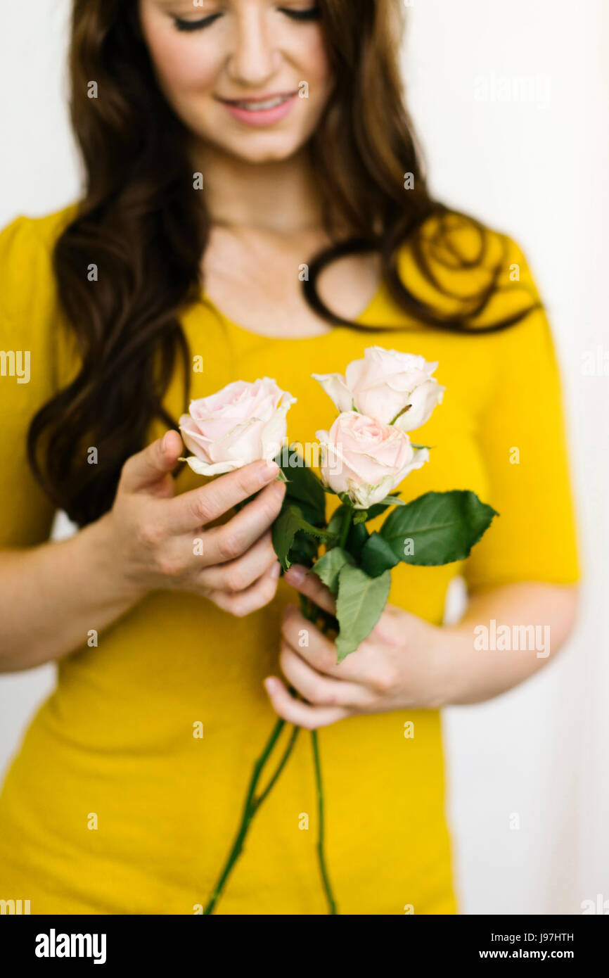 Woman holding roses Stock Photo - Alamy