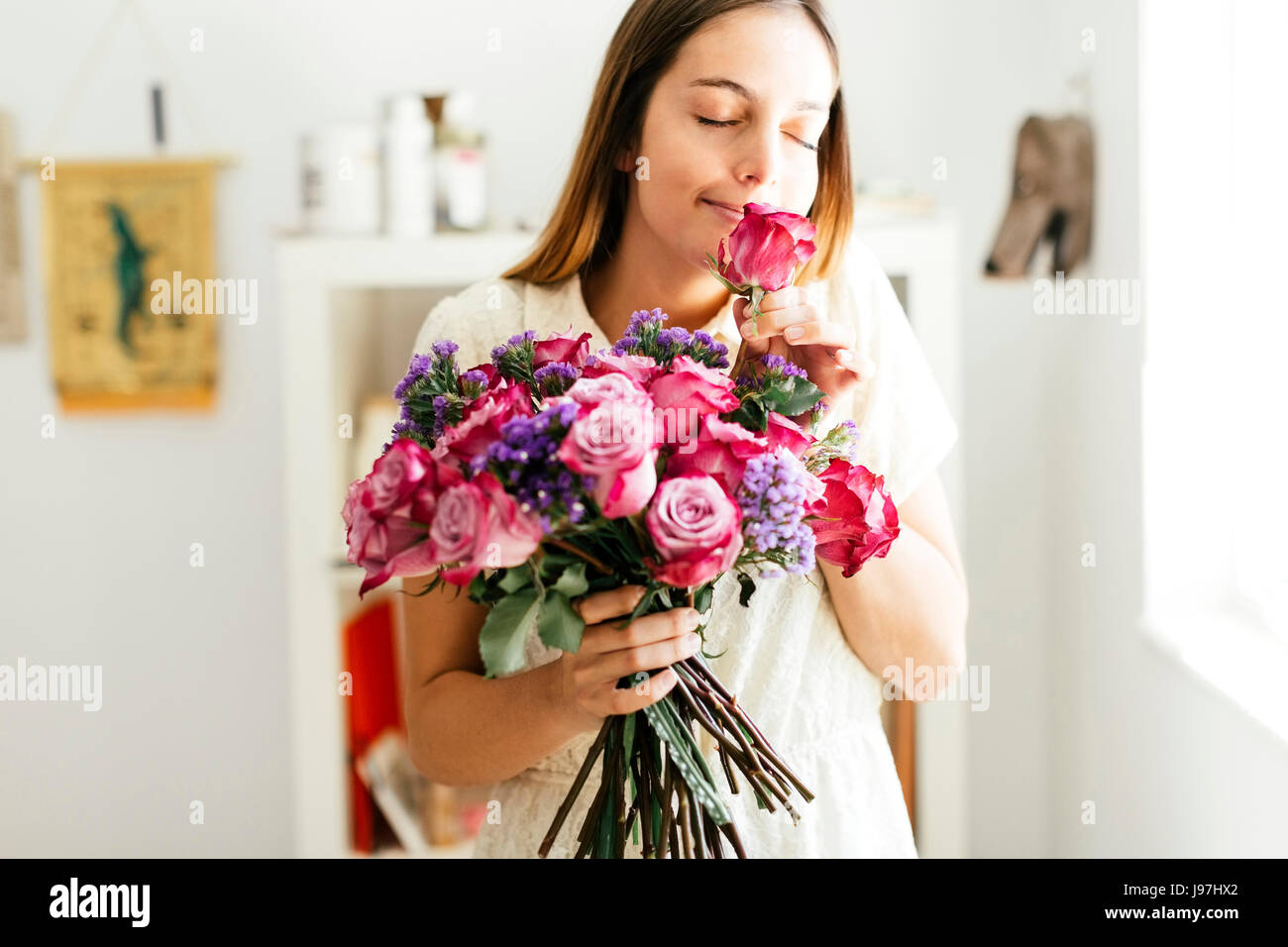 Beautiful woman smelling roses hi-res stock photography and images - Alamy